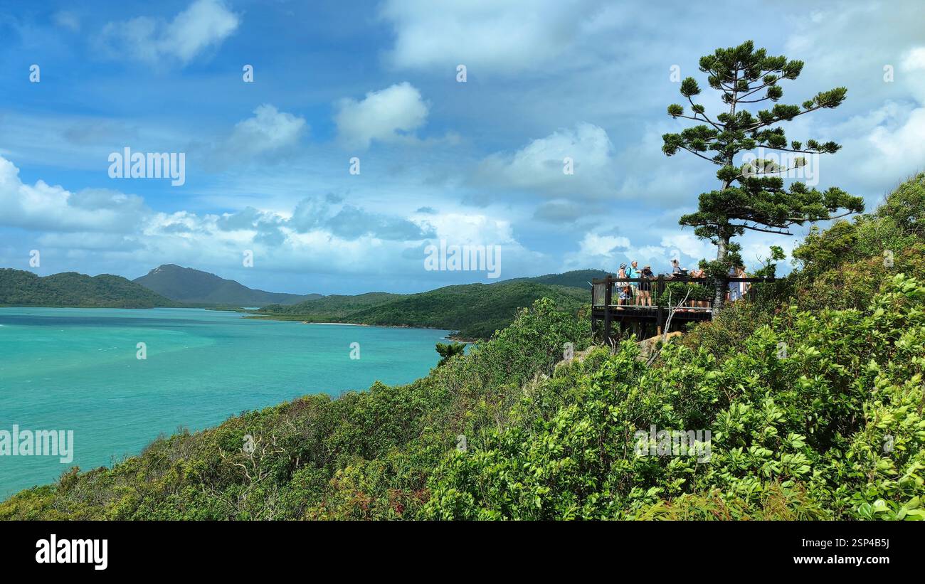 A group of people stands on a platform overlooking the ocean at Hill ...