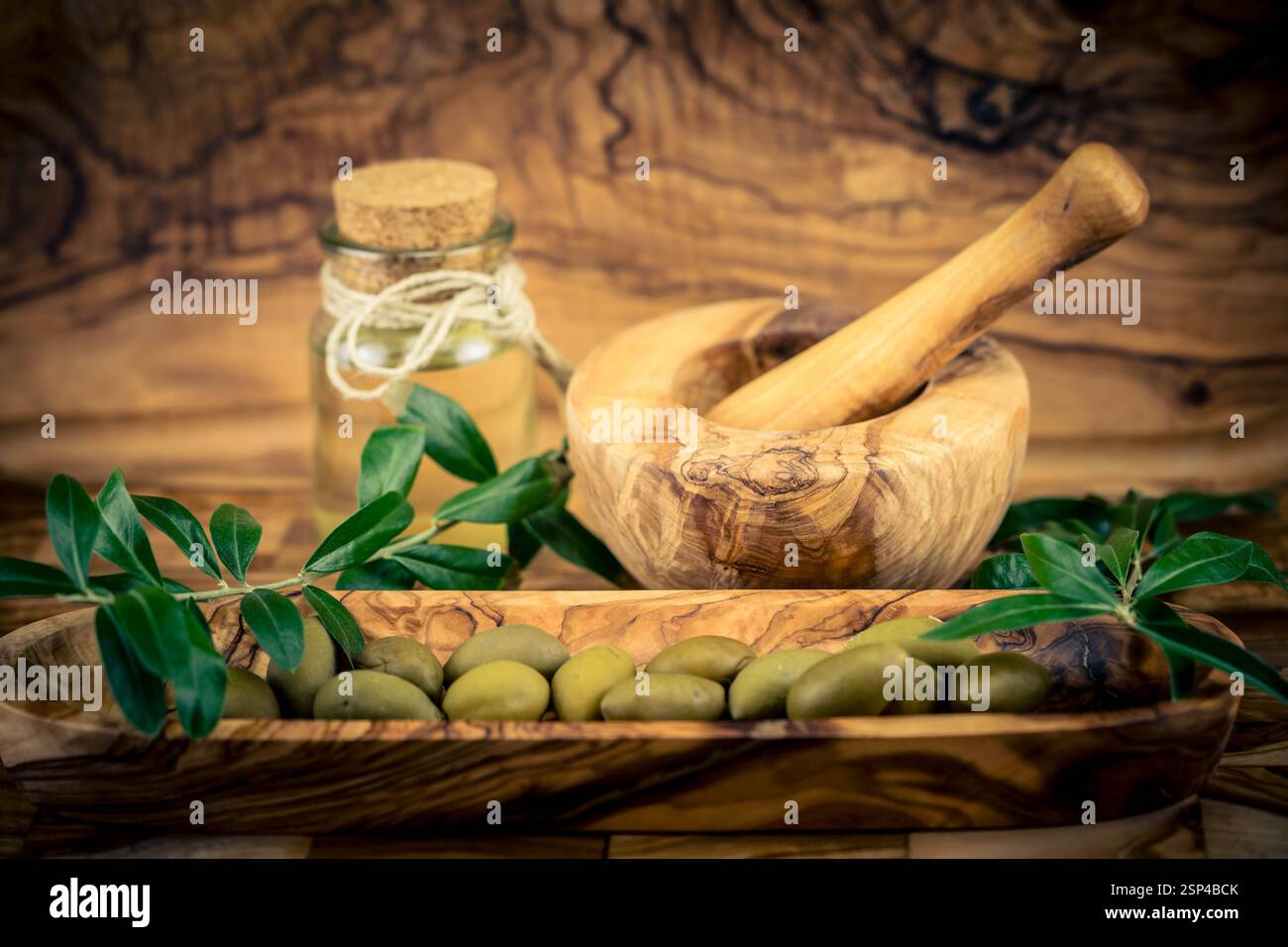 cold pressed extra virgin olive oil on olive wood Stock Photo - Alamy