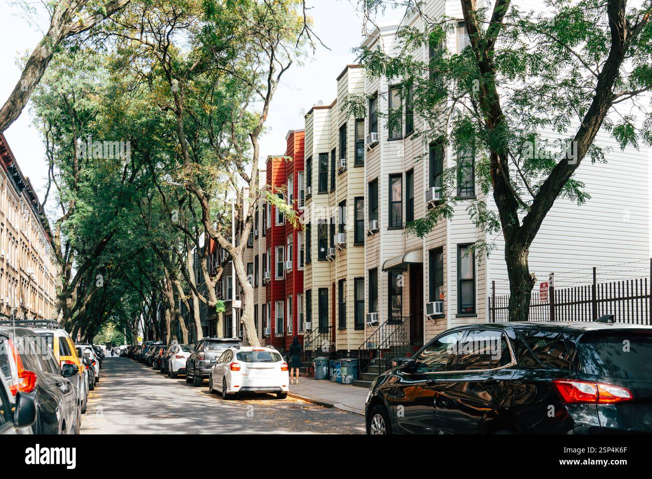 Colorful buildings line a lively street in New York City, displaying a ...