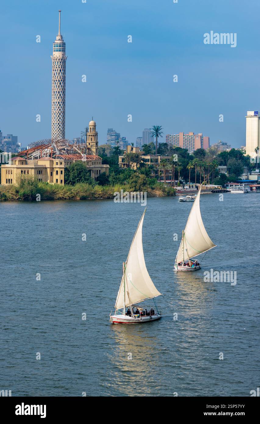 Two boats sailing on the Nile River in Egypt with Cairo tower in ...