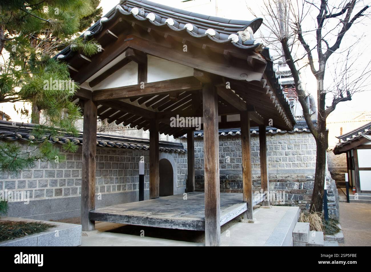 Pavilion in South Korea. Wooden structure with tiled roof, supported by ...