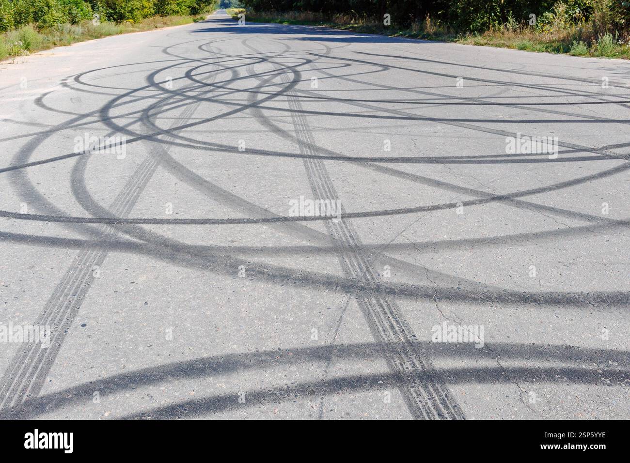 Skid marks on the road surface. Circular tire tracks left by drivers ...