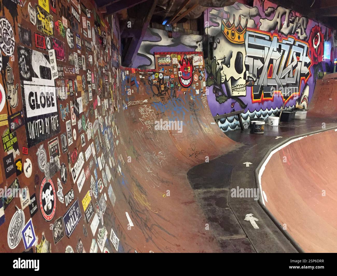 Skaters enjoy an indoor skate park featuring a smooth halfpipe and ...