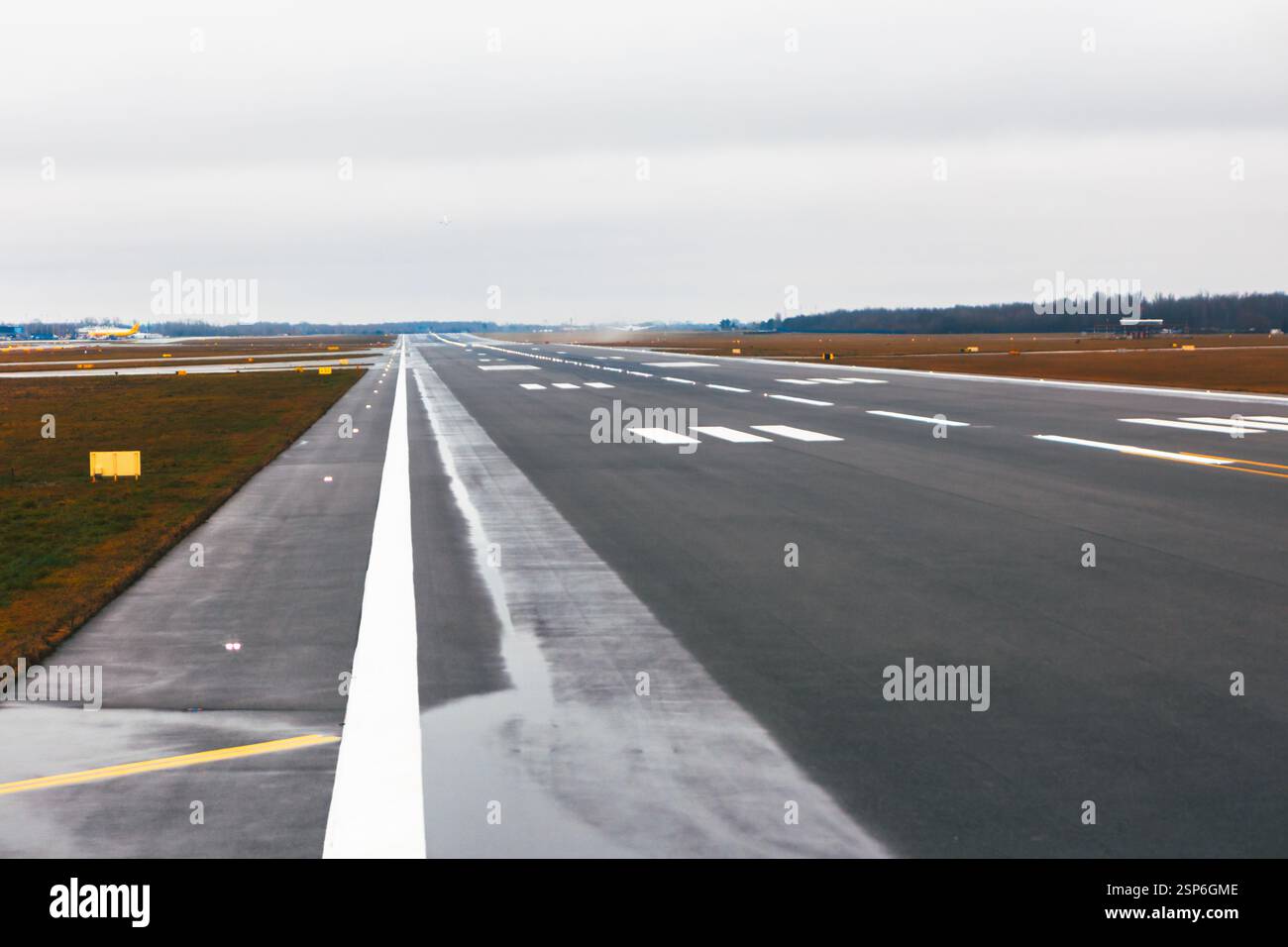Long empty runway at an airport, stretching into the distance under a ...