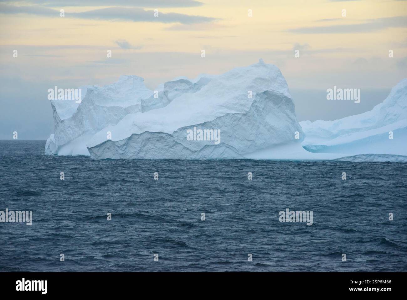 A massive iceberg floating in the frigid waters of the Antarctic Ocean ...