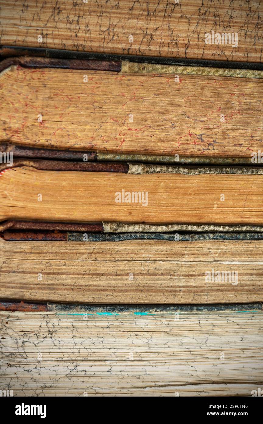 Textured stack of old books close up. Close up of old paper pages of book. Concept of reading ...