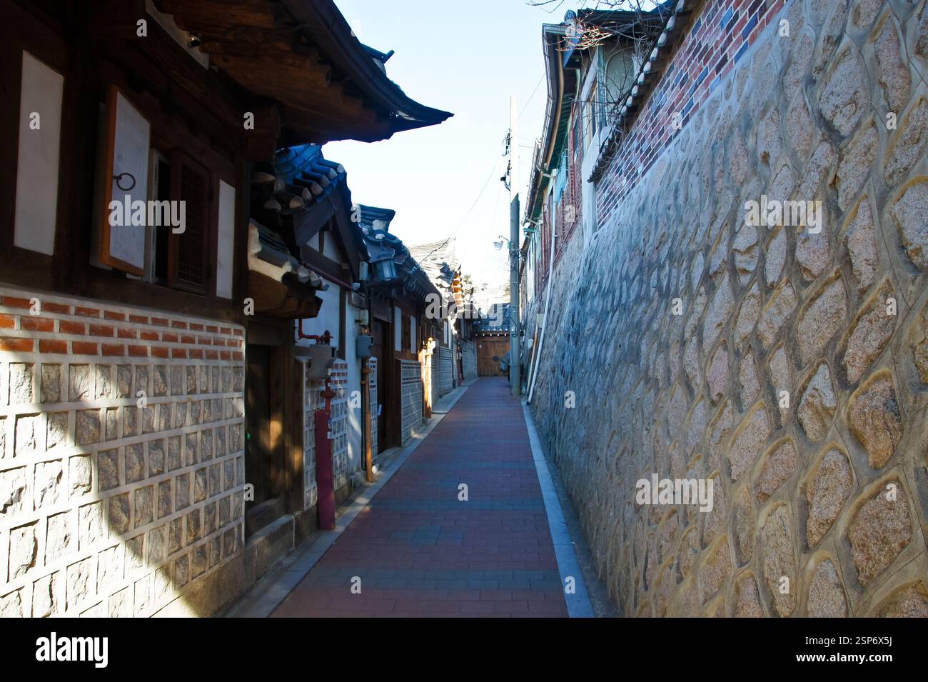 Bukchon Hanok Village alleyway. Traditional Korean houses line a narrow ...