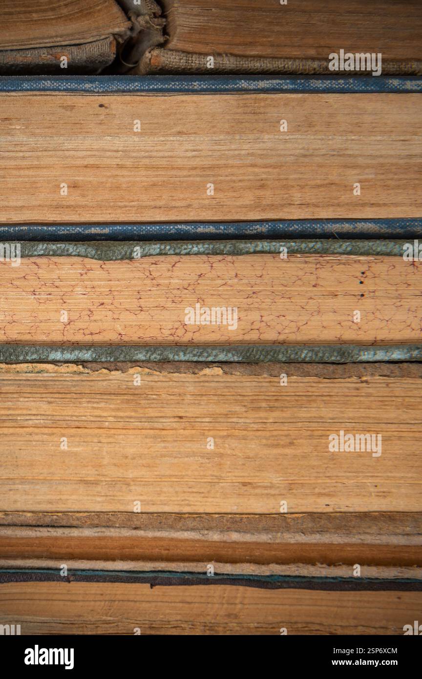 Textured stack of old books close up. Close up of old paper pages of book. Concept of reading ...