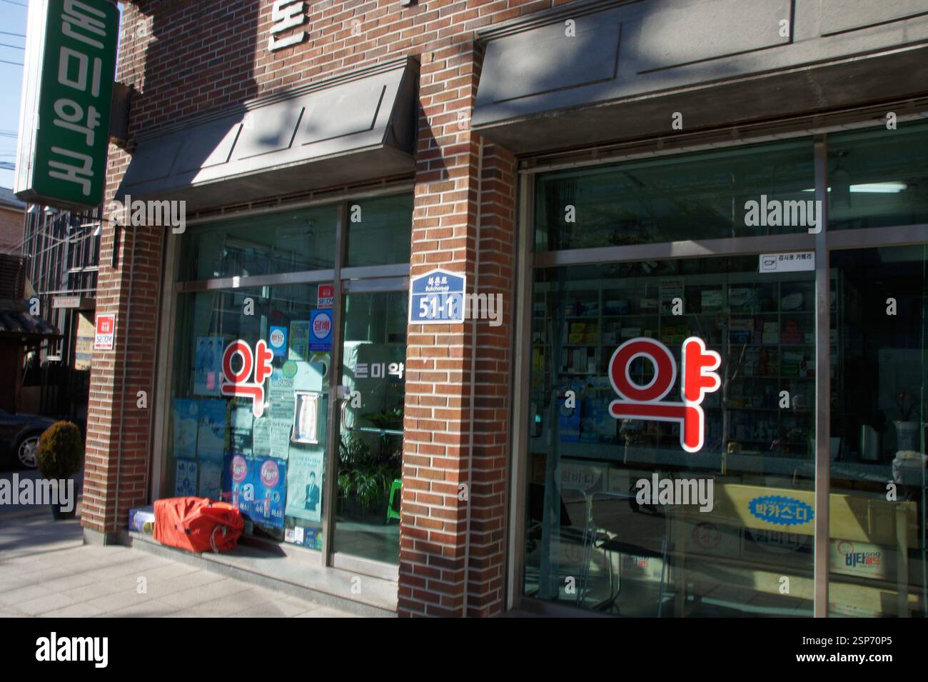 The storefront is a red brick building with large windows filled with ...