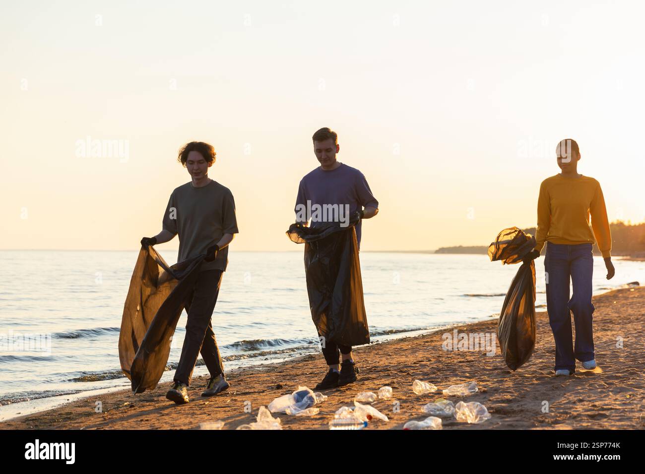 Earth day. Volunteers activists team collects garbage cleaning of beach ...