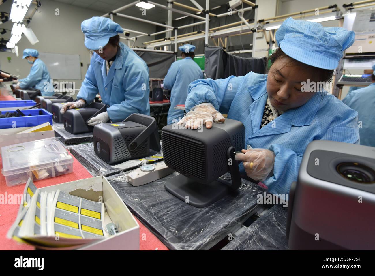 Workers work at a workshop of a smart projector production base in ...