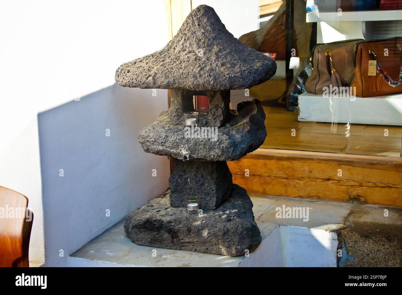 The photo shows a stone lantern in South Korea. It has a multi-tiered ...