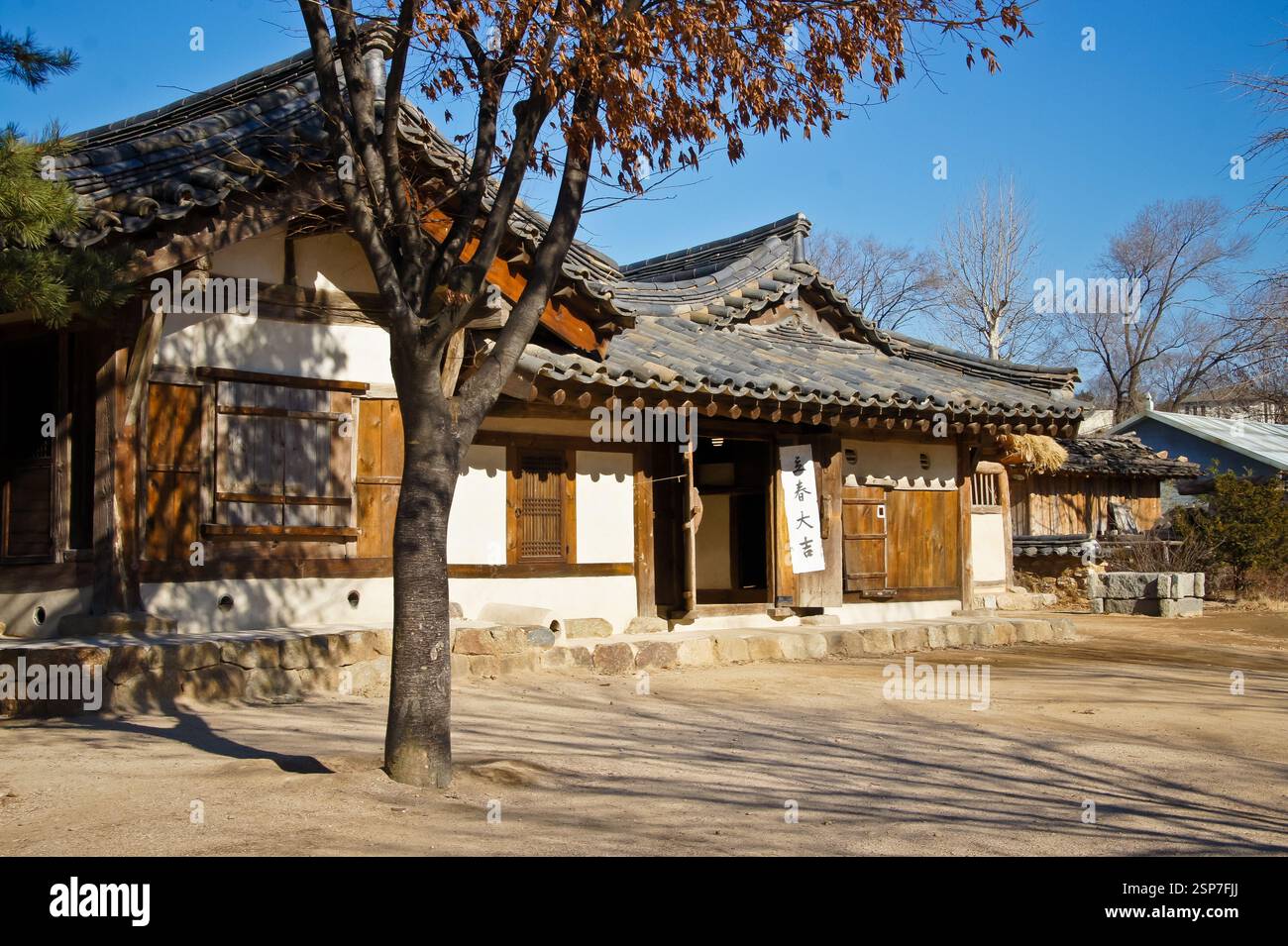 Hanok, a traditional Korean house with tiled roof and white walls, is a ...