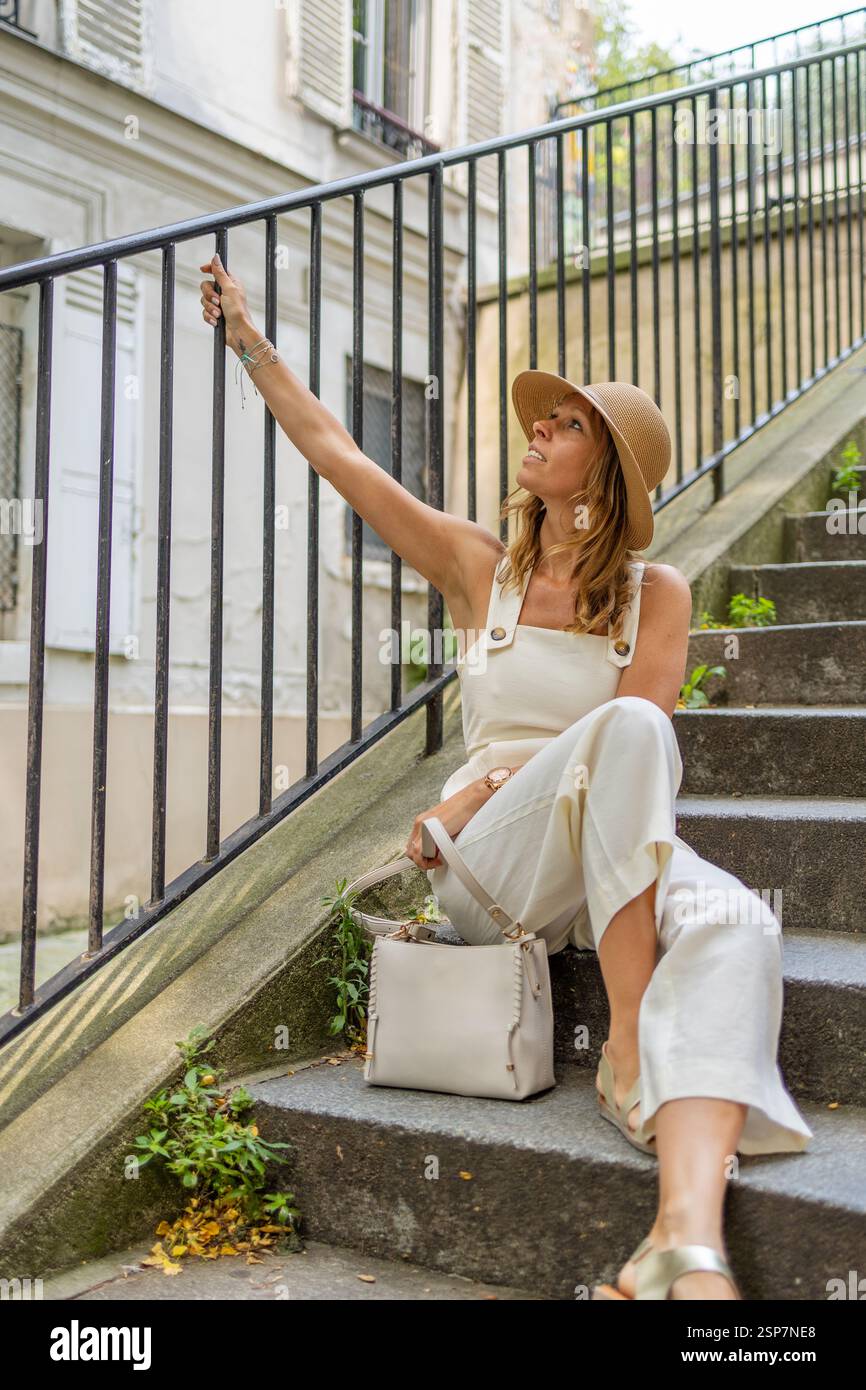 Elegant woman relaxing on Parisian stairs in summer fashion Stock Photo ...