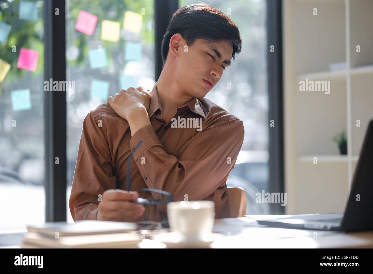 Tired worker experiencing neck and shoulder pain prolonged work hours ...