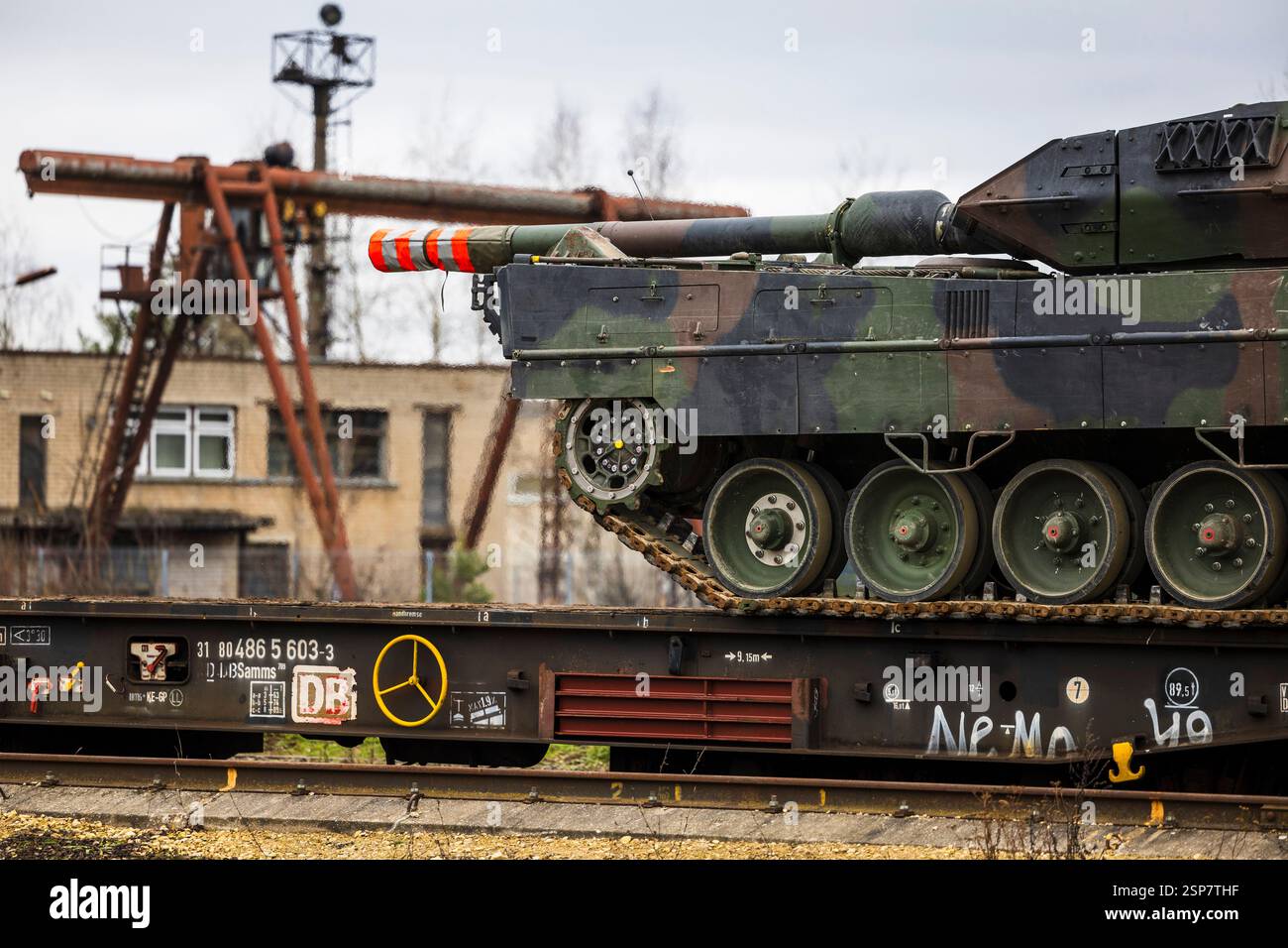 A convoy of German Leopard 2 main battle tanks loaded onto flatbed ...
