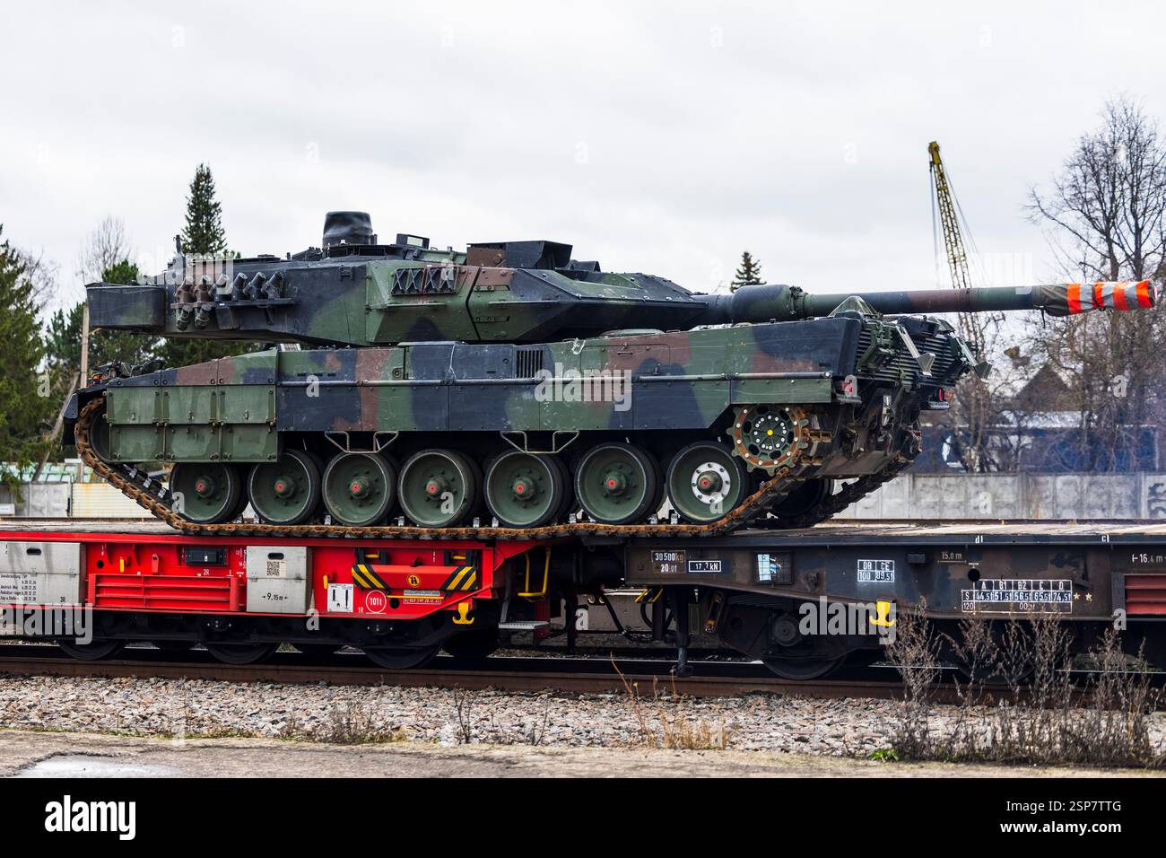 A convoy of German Leopard 2 main battle tanks loaded onto flatbed ...