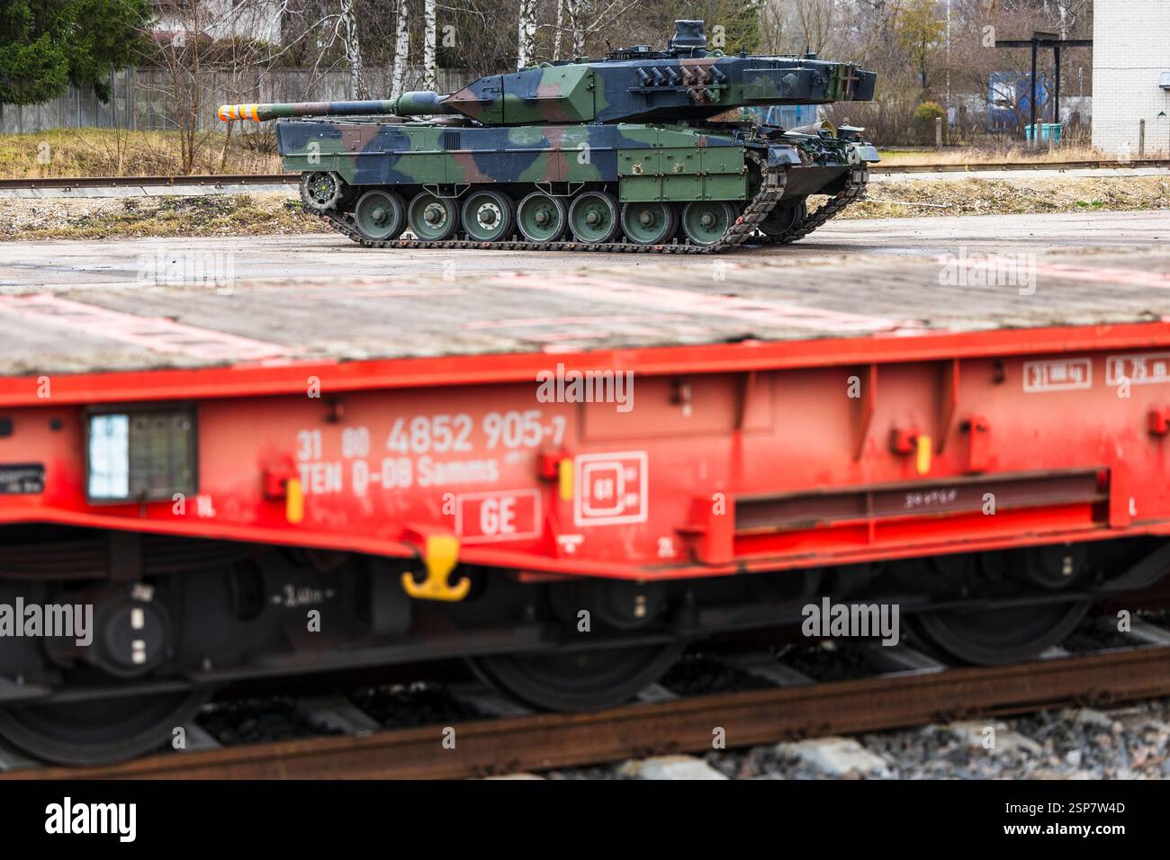 A German Leopard 2A7 main battle tank parked near a railway flatbed car ...