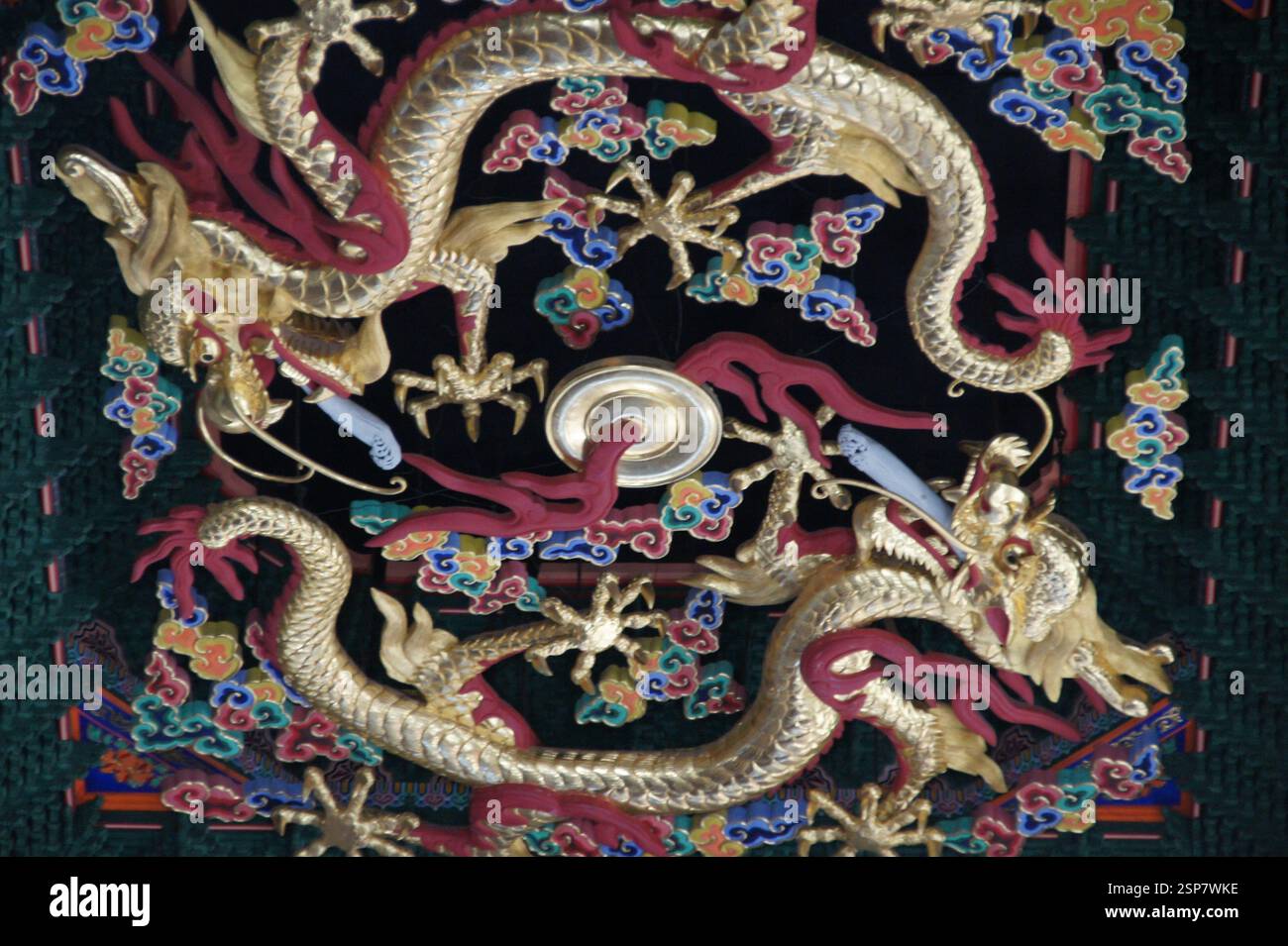 Two golden dragons entwined, vibrant colors on a black background ...