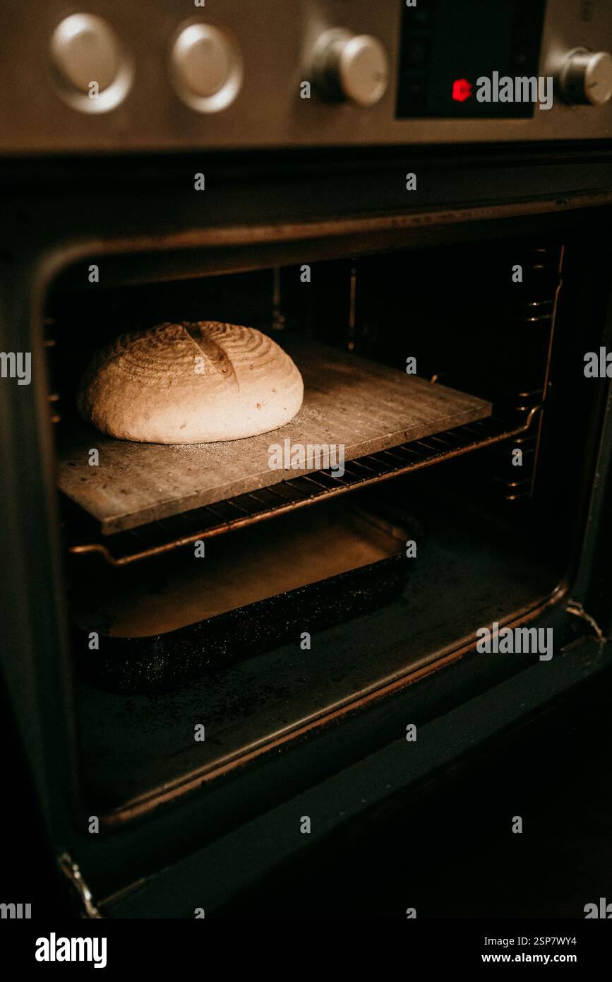 A loaf of bread dought in the oven on a baking stone Stock Photo - Alamy