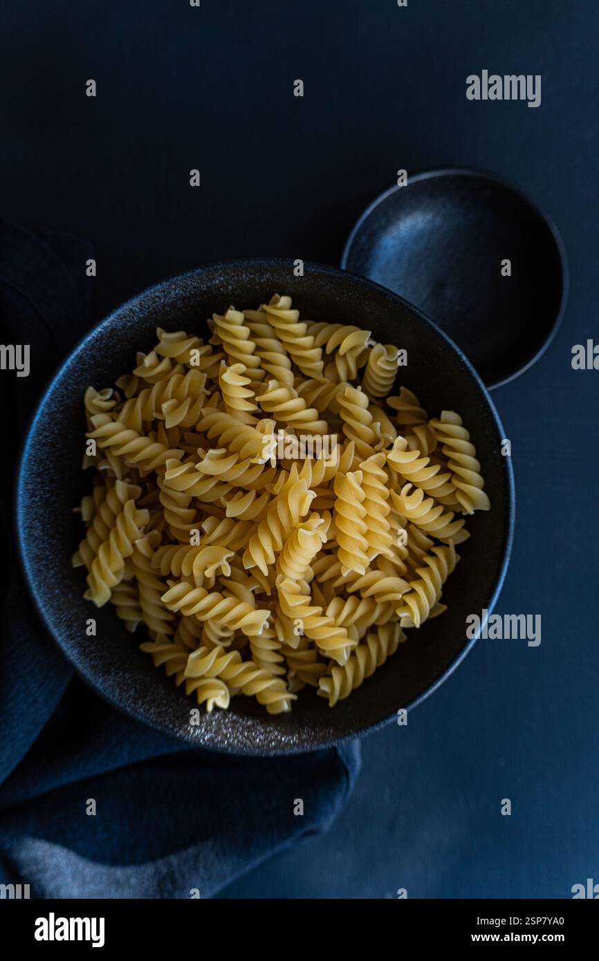 Raw fusilli pasta in the bowl Stock Photo - Alamy