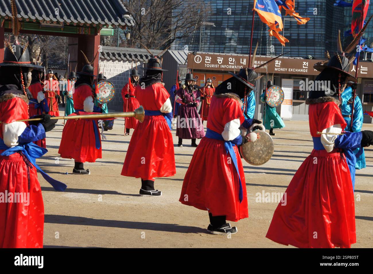 Korean guards in colorful uniforms and hats perform a ceremony. They ...