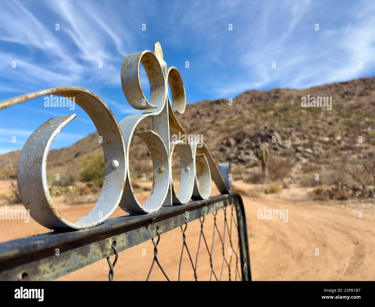 Close-up of rustic metal gate with desert mountains in Congress, AZ ...