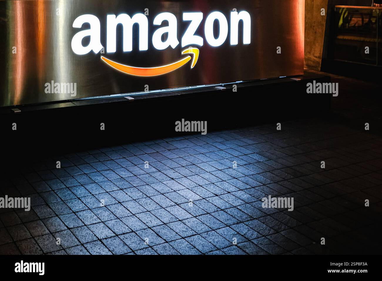 Illuminated neon Amazon company logo signboard on the logistics centre ...