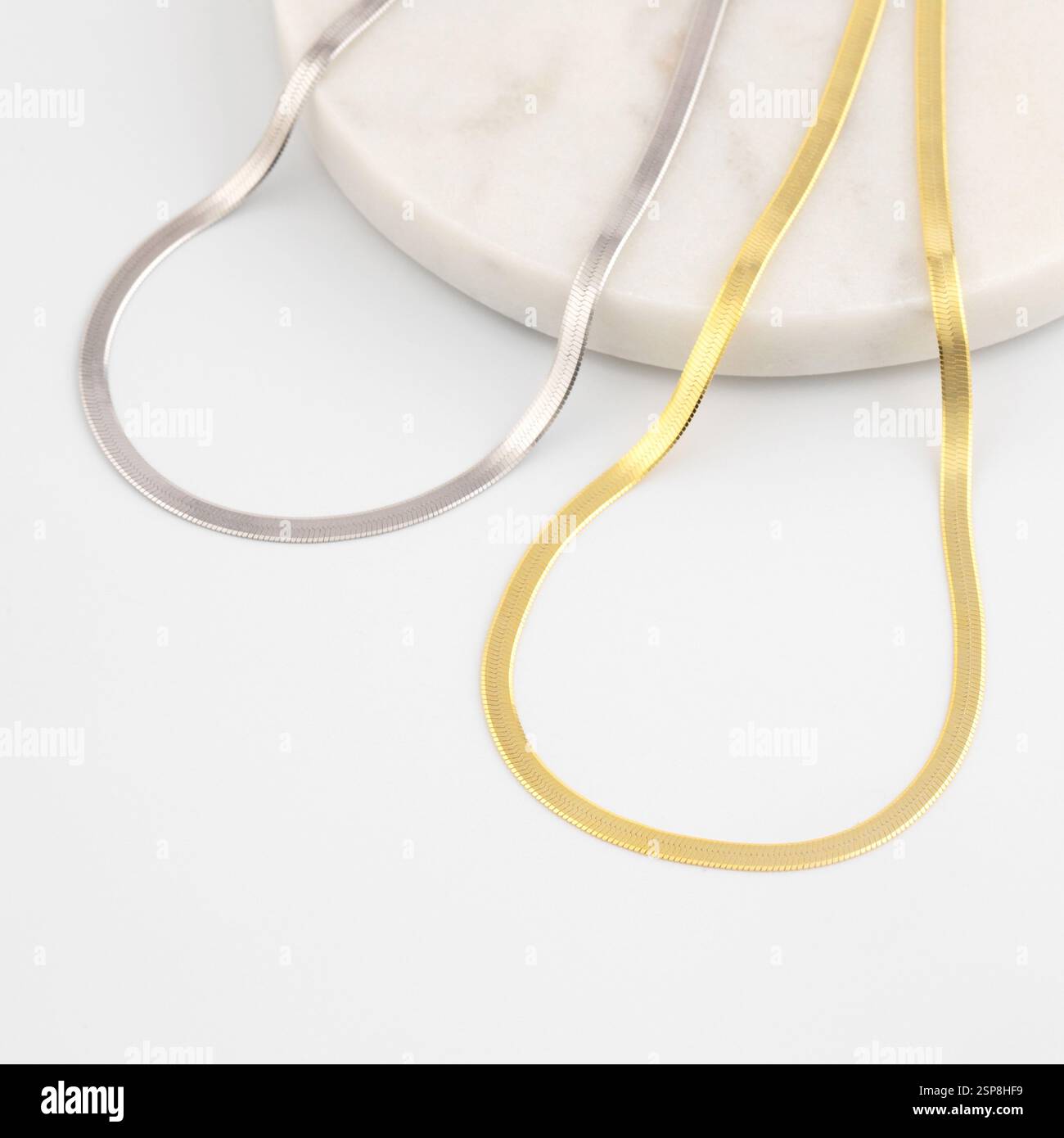 Elegant gold and silver chains on a white background. jewelry. Chain ...