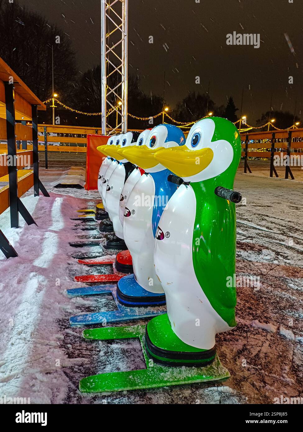 Colorful penguins for children's skating are lined up near the ice rink ...
