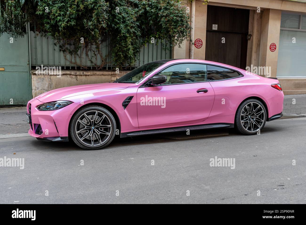 Paris, France, 02.13.2025 A pink BMW M4 G82 car in a Parisian street ...