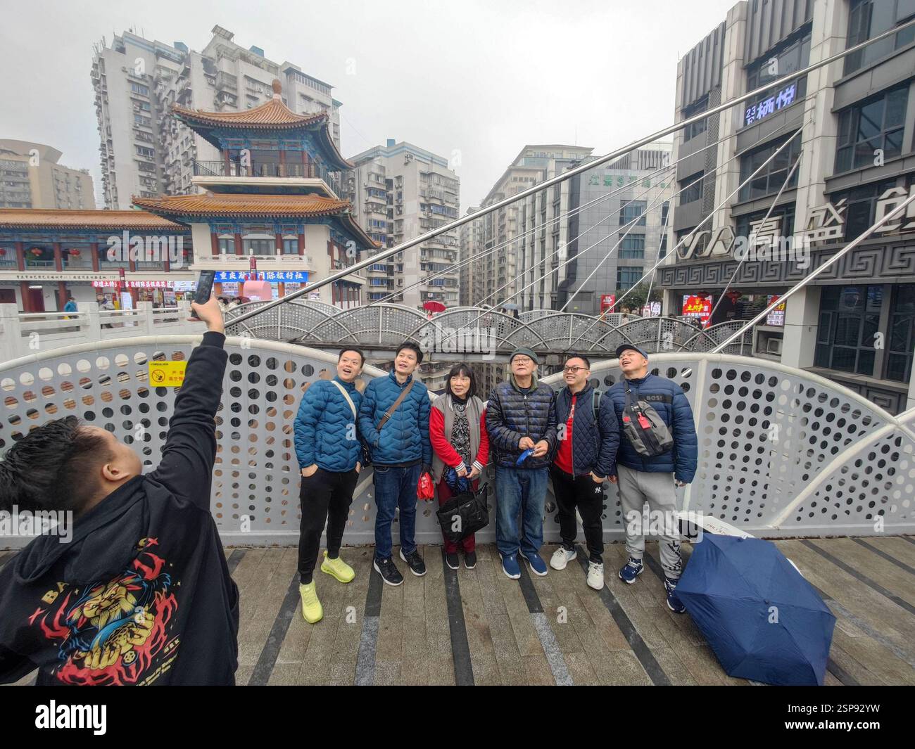 CHONGQING, CHINA - FEBRUARY 14, 2025 - Tourists overlook the city view ...
