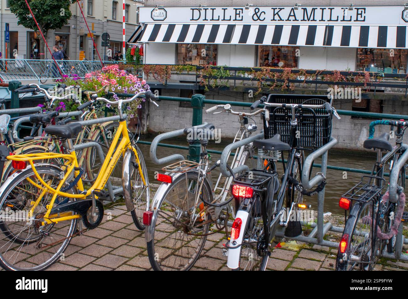 Bicycles in Ghent cityscape, promenade of Lys river with Saint Michael ...