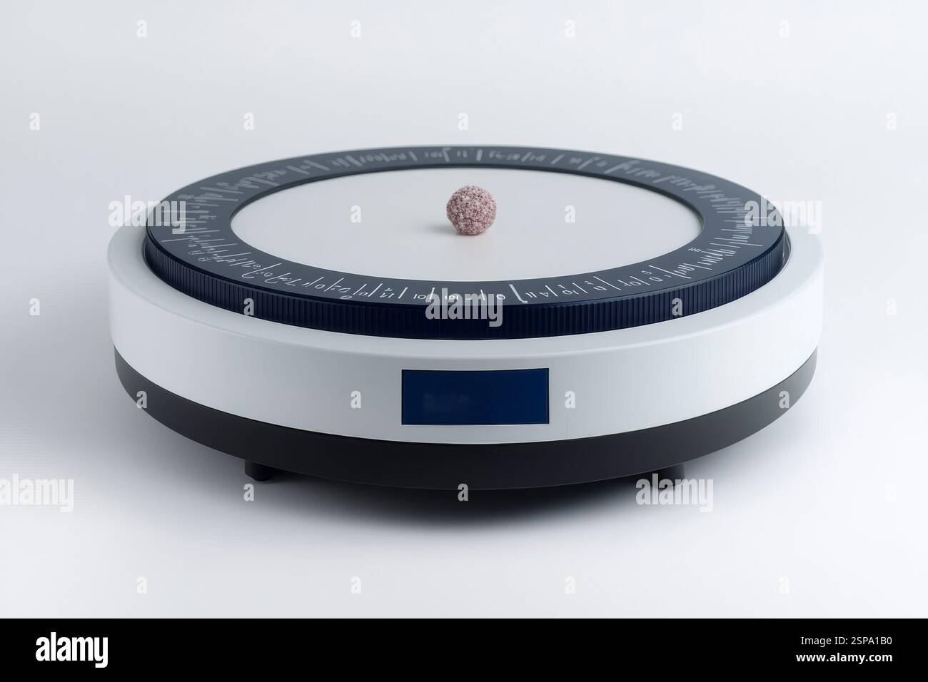 A small spherical object rests on a precision turntable while it ...