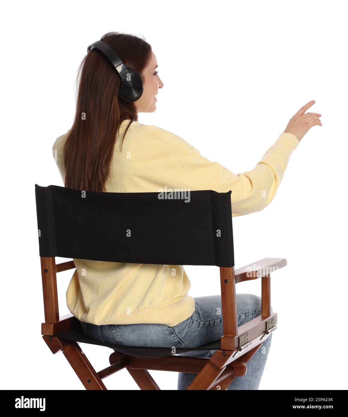 Woman with headset sitting in director's chair on white background ...