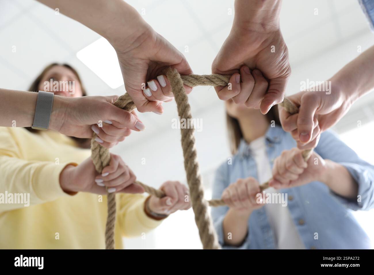 Unity concept. People holding rope together indoors, bottom view Stock ...