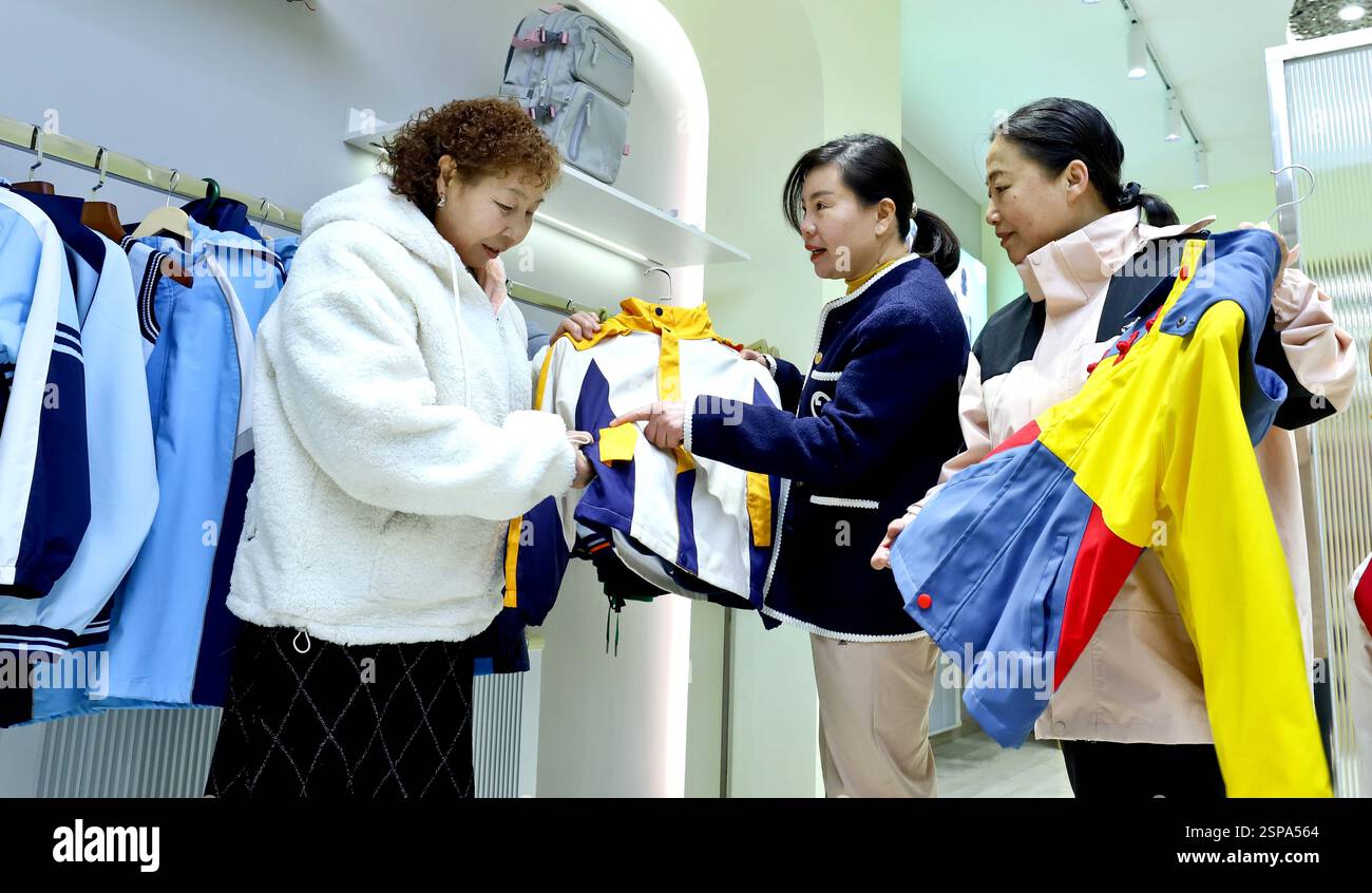 ZHANGYE, CHINA - FEBRUARY 14, 2025 - A staff member introduces new ...