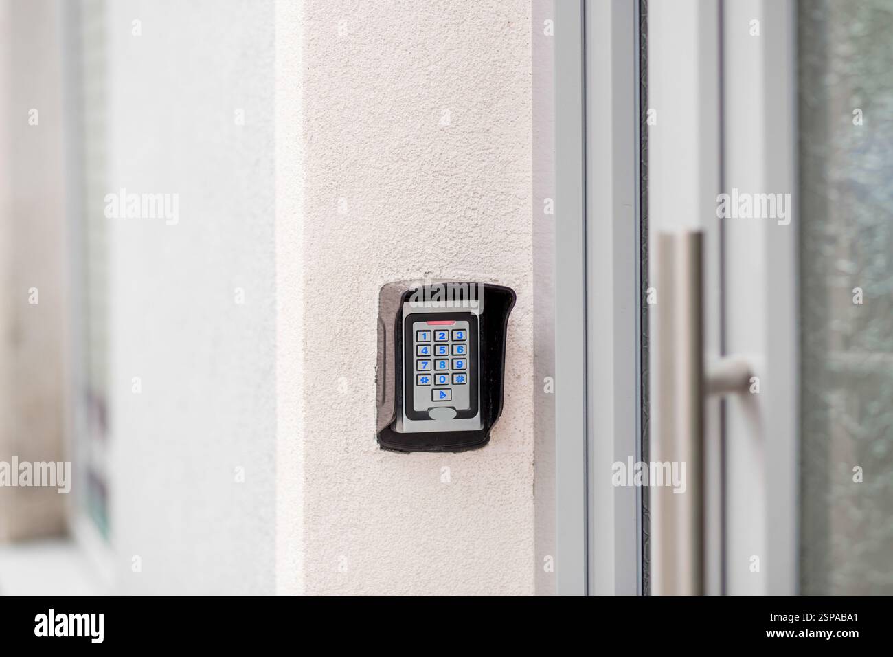 Intercom system with a keypad is mounted on a beige textured wall Stock ...