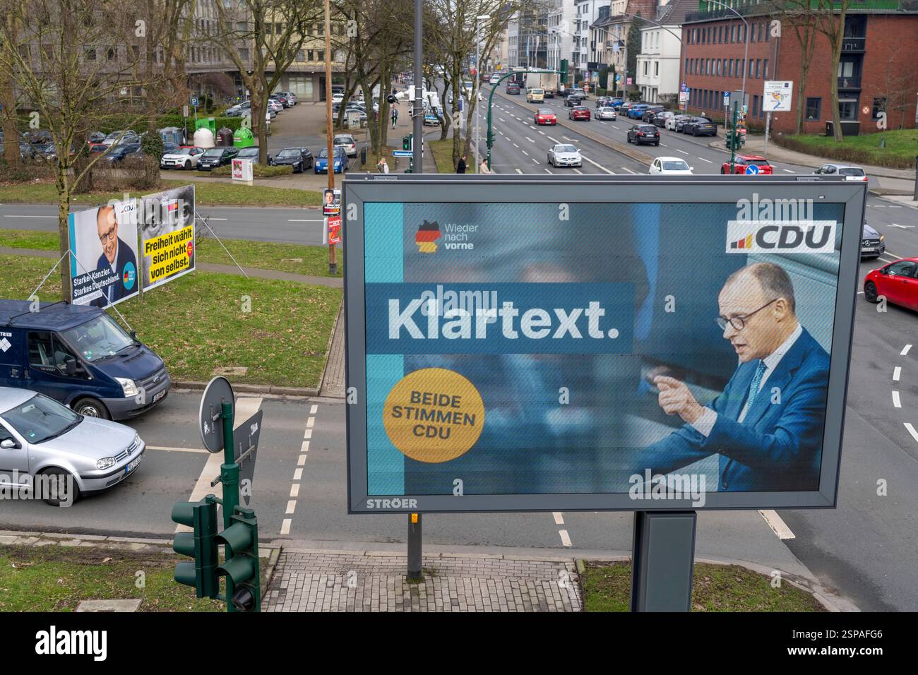Digital billboard with CDU election advertising, behind it analogue, printed large-scale ...
