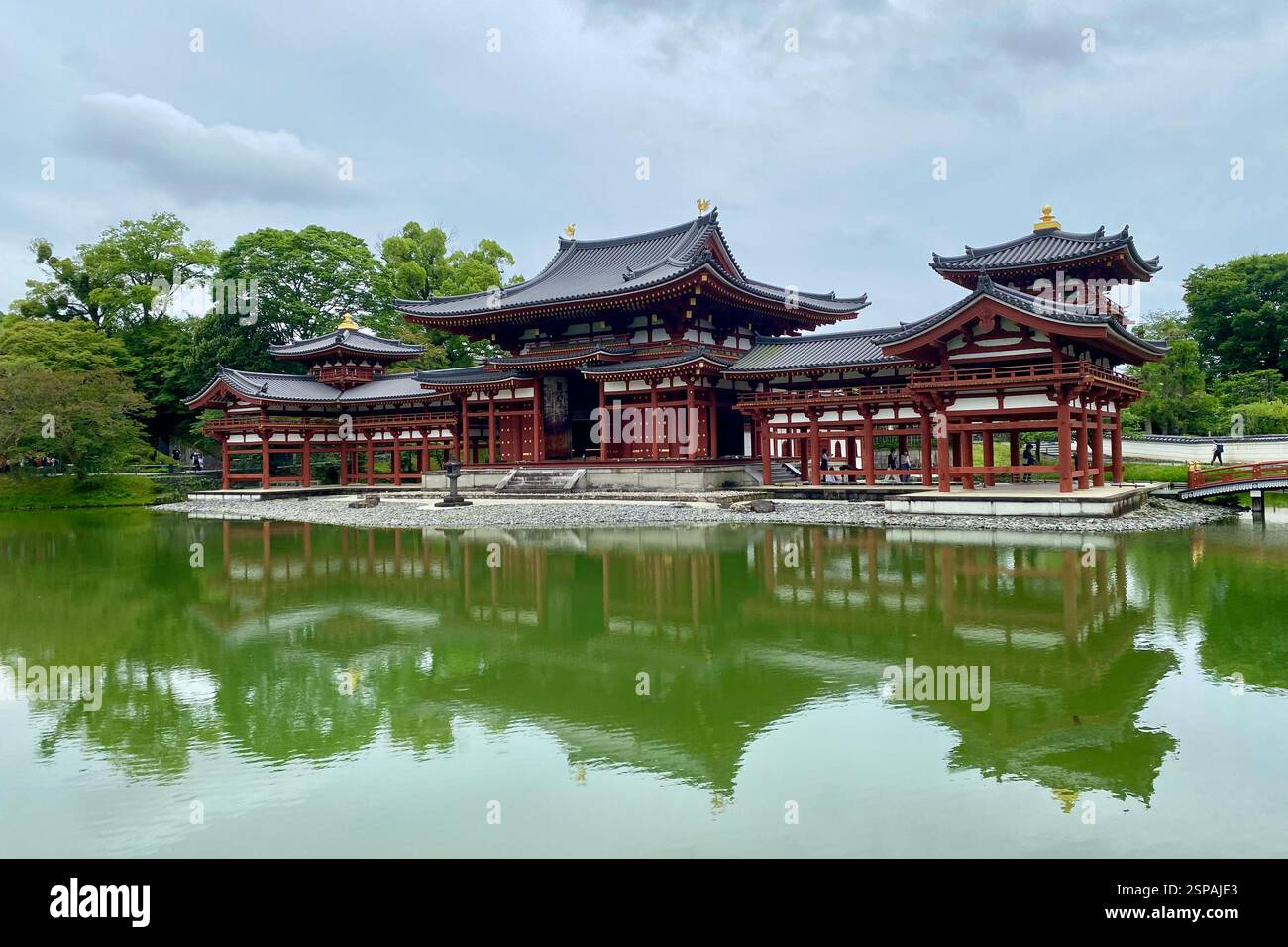 The red and beautiful Byodo-in, the Phoenix temple in front of a green ...
