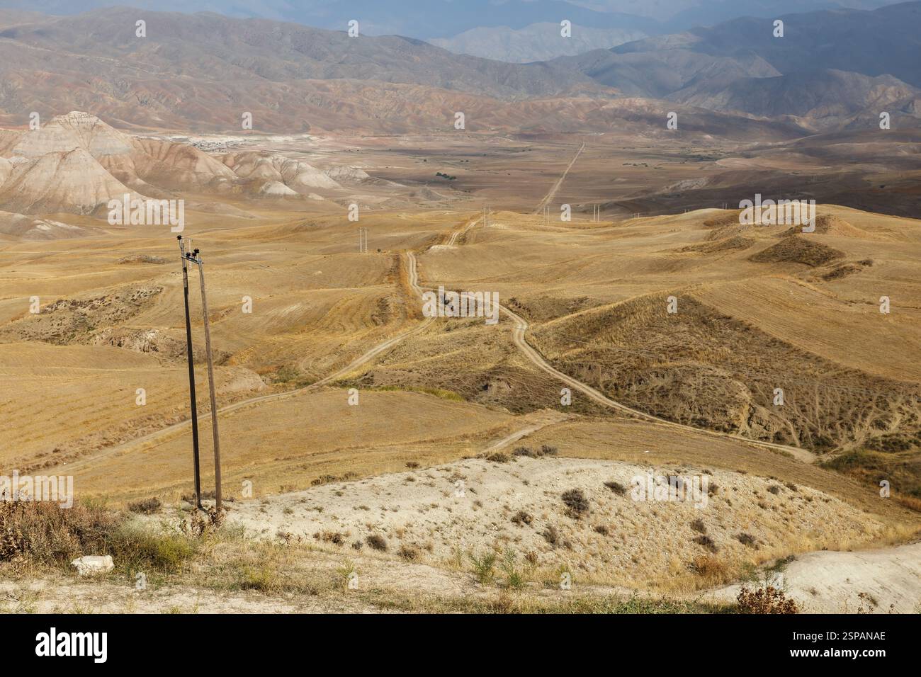 A sweeping view of the arid terrain in Iran features rolling hills ...