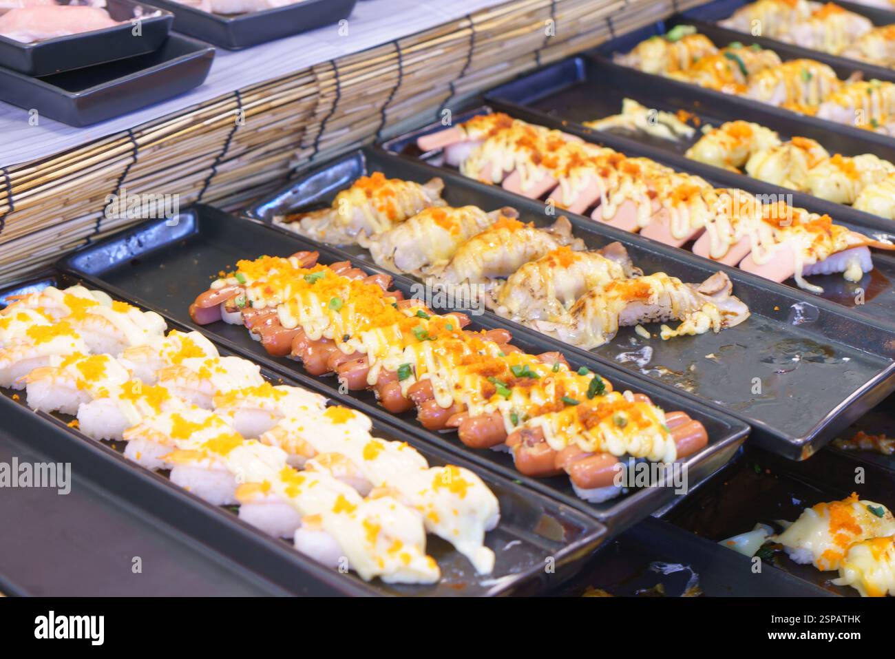 close-up shot of assorted sushi varieties displayed at a street food ...