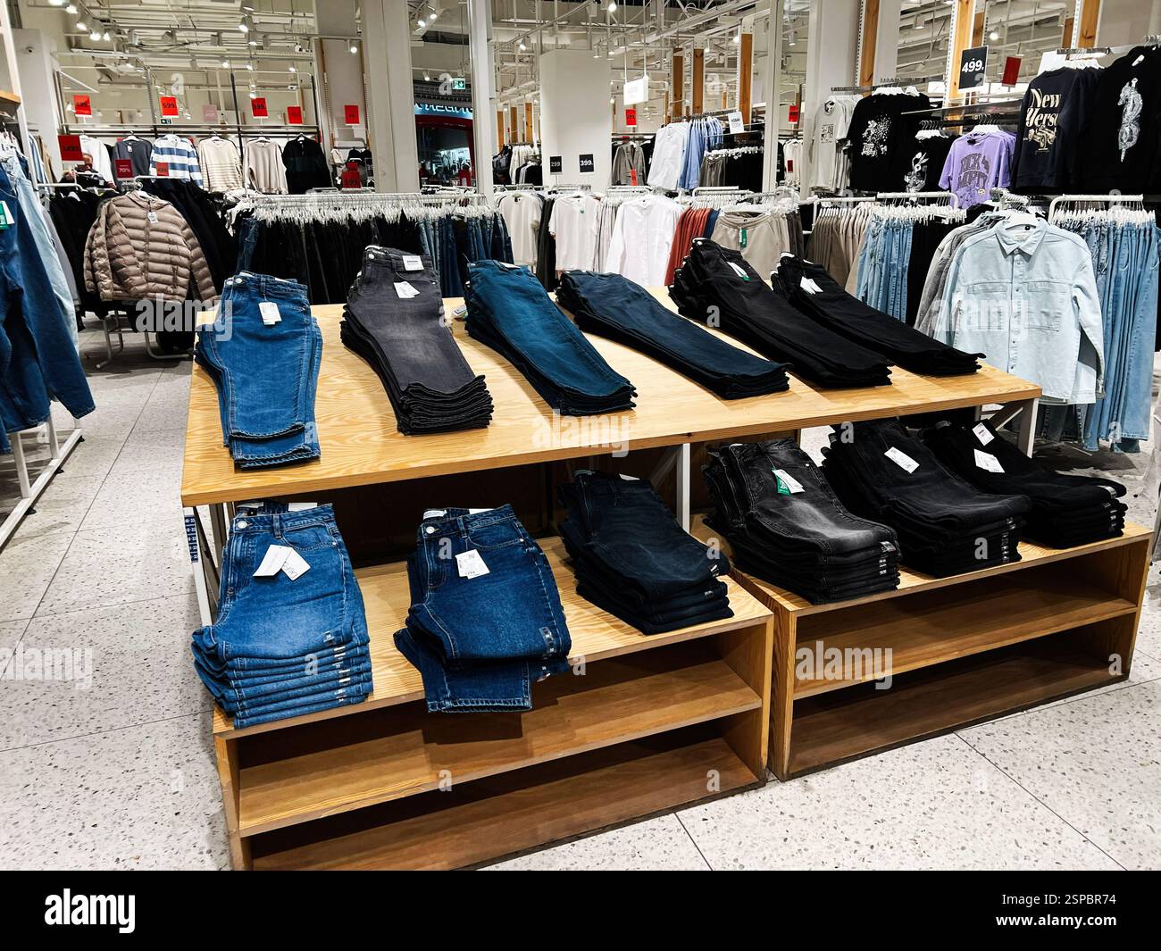 Lviv, Ukraine - February 13, 2025: Assortment of jeans neatly stacked ...
