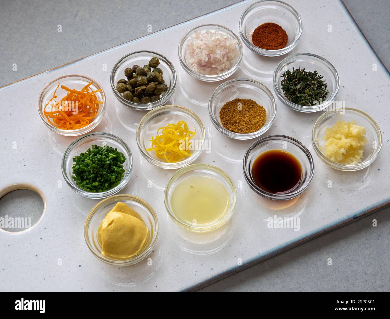 Neatly laid out flavouring ingredients on a chopping board showing ...