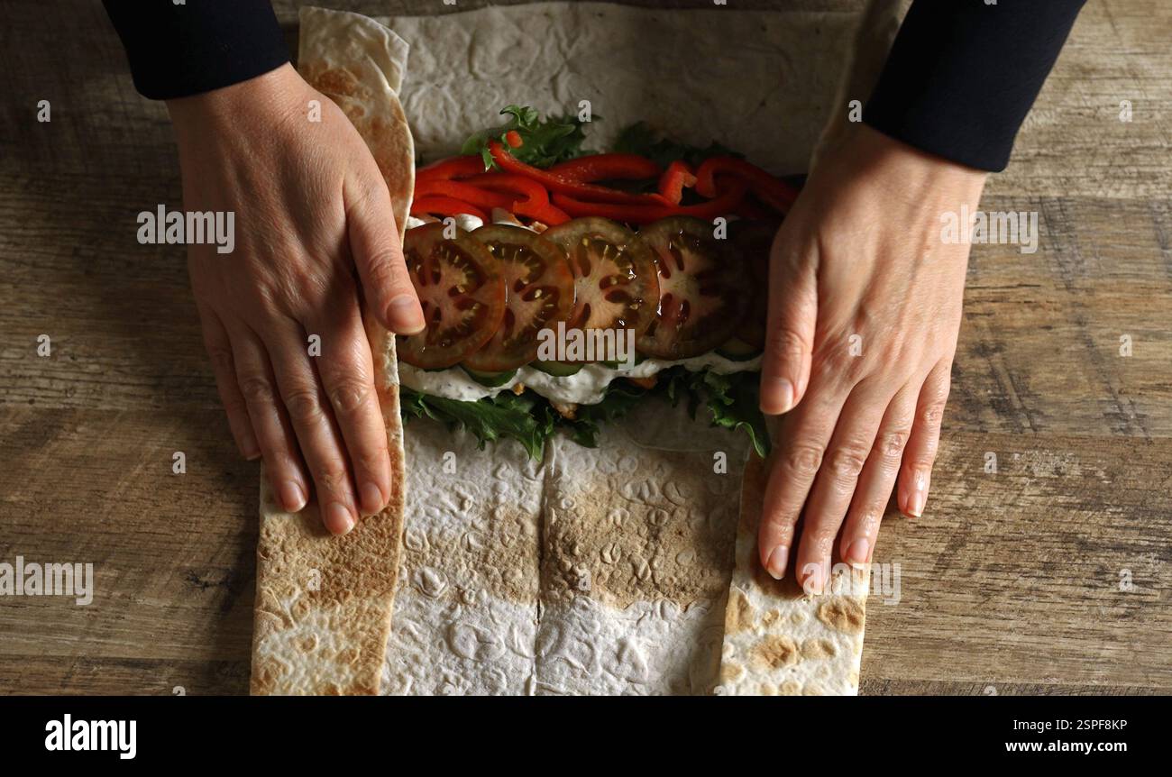 Hand wrapping traditional shawarma beef hi-res stock photography and ...