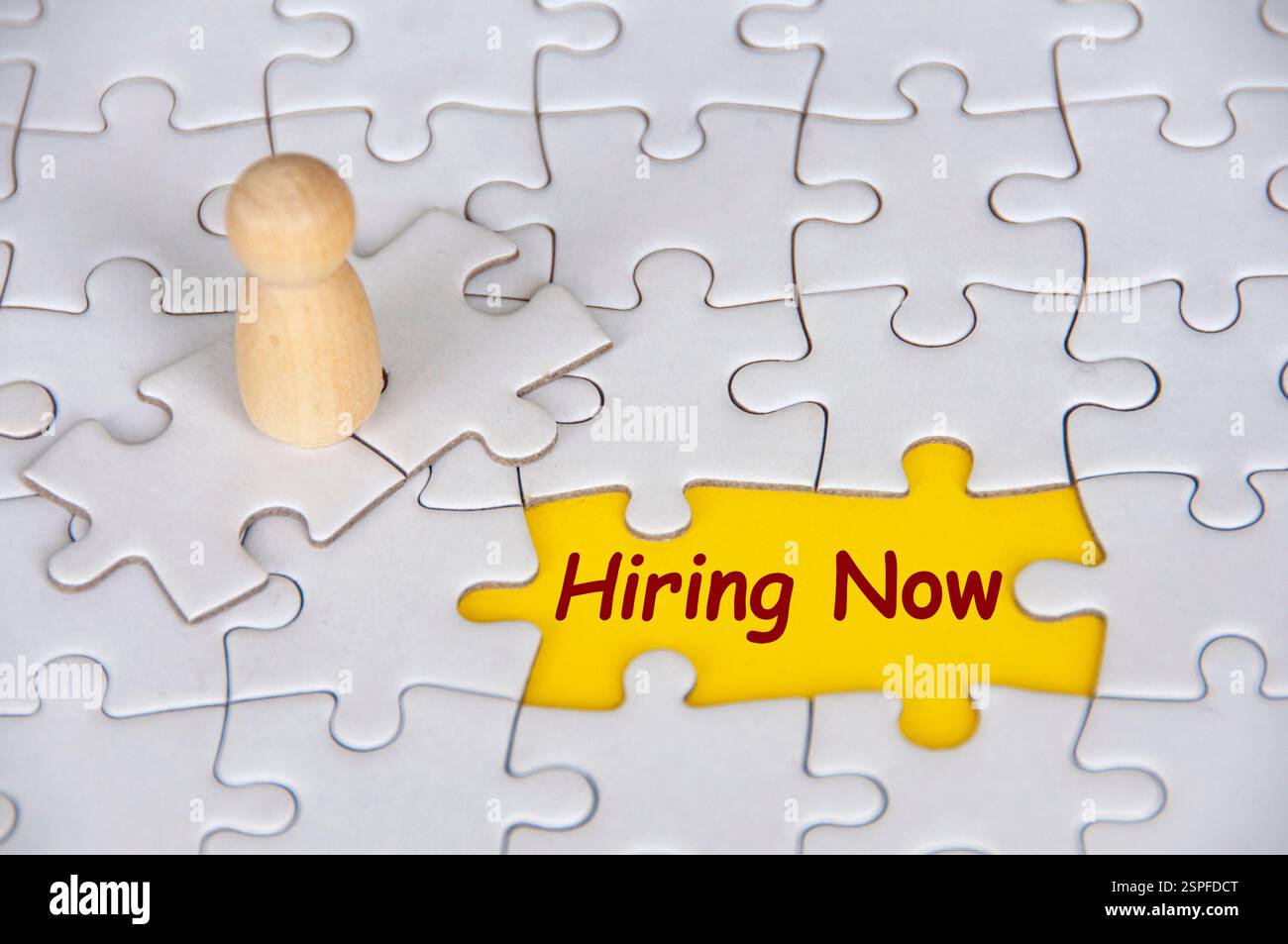 Hiring Now text on jigsaw puzzle with wooden doll background Stock ...