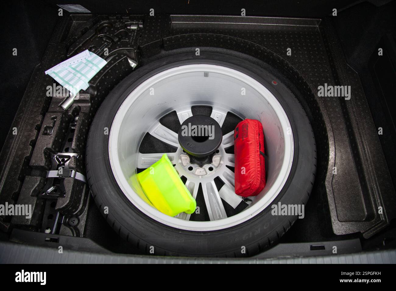 Spare tire, reflective vest, first aid kit and emergency sign in the ...