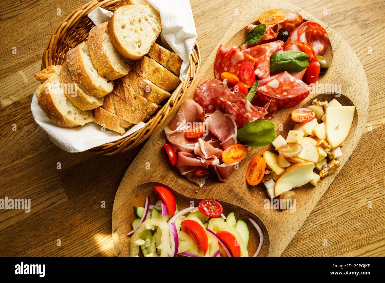 A rustic charcuterie board featuring an assortment of cured meats ...