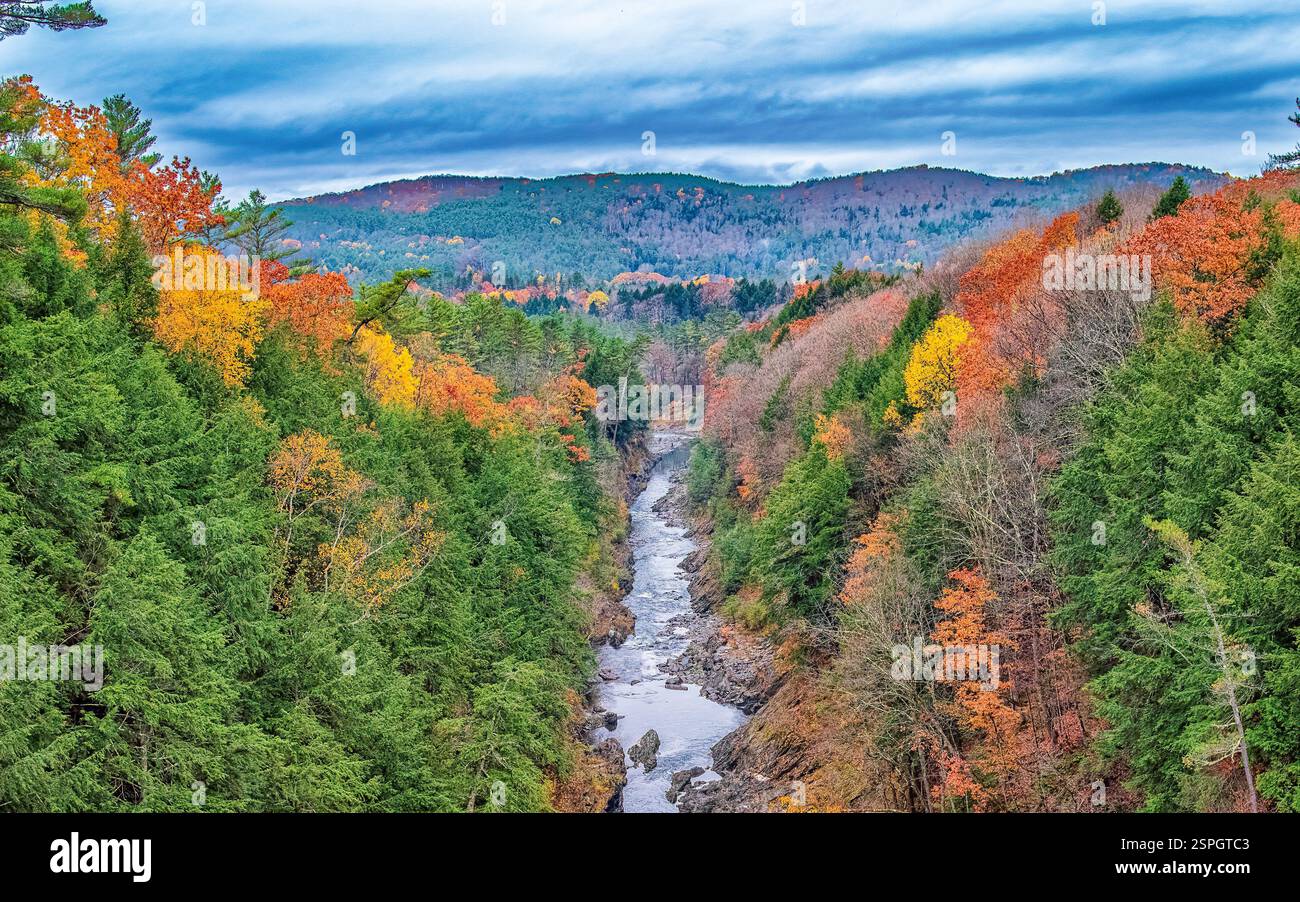 A mountain river winds through a vibrant autumn landscape, surrounded ...
