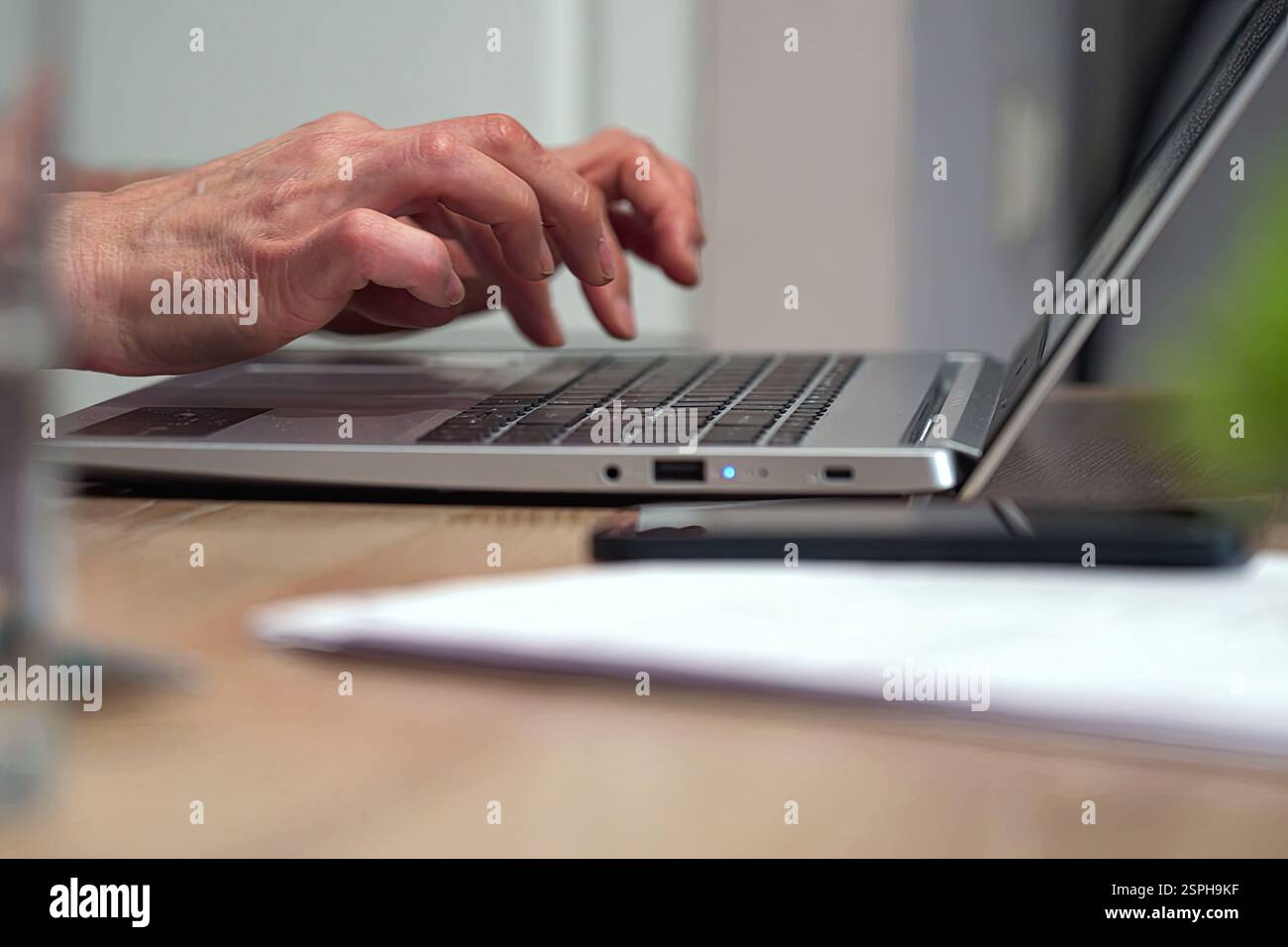 Keeping a personal diary: a woman writes down her thoughts and types ...